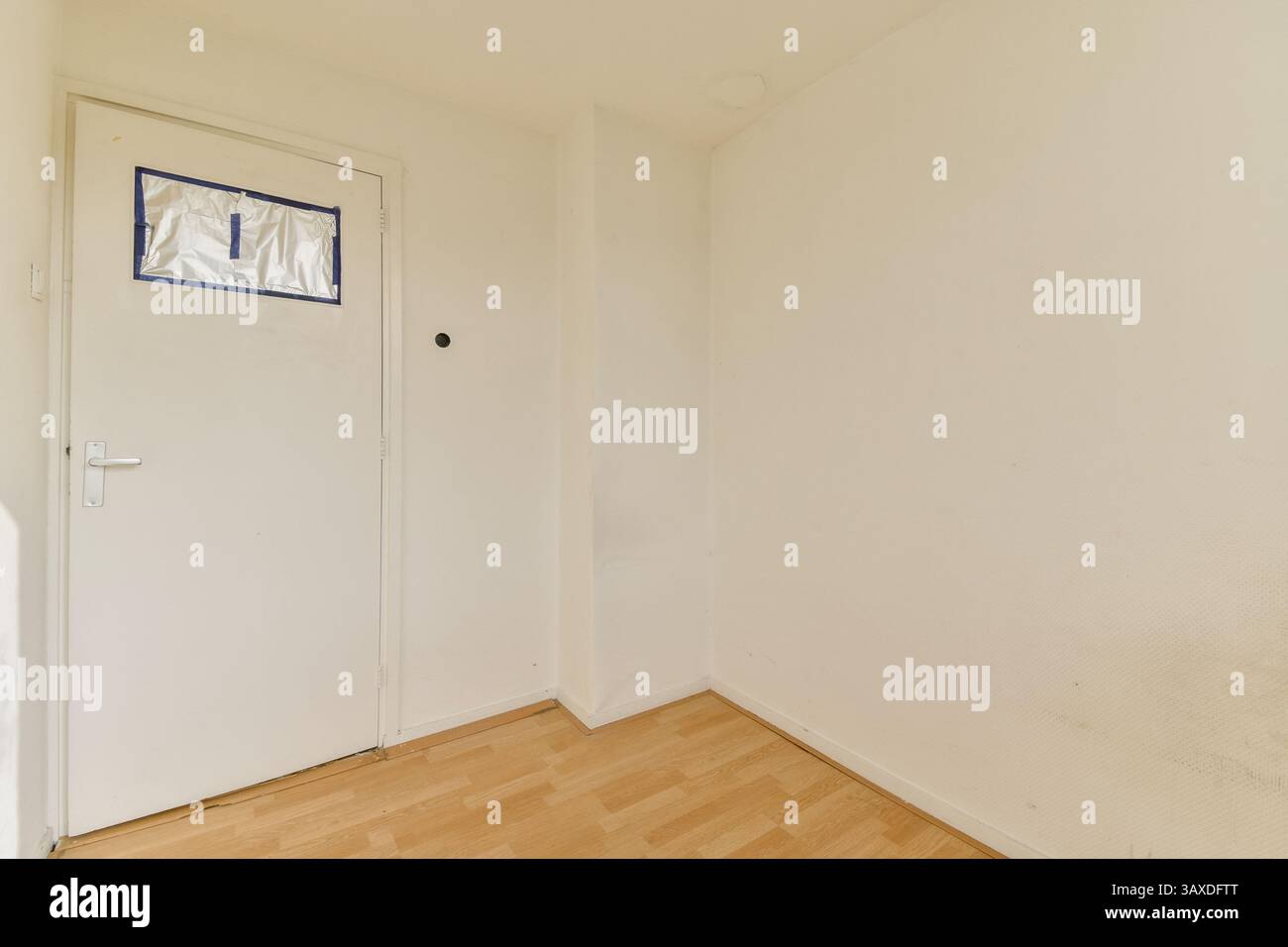 A minimalistic view of an empty hallway featuring a white wall and a ...