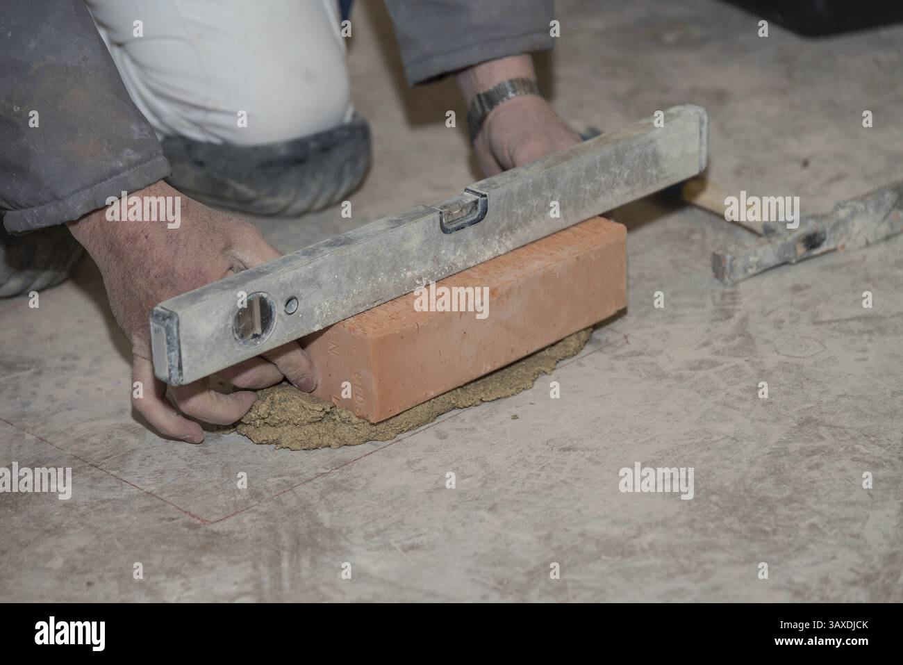 Craftsman from the building trade masonry with brick and mortar - close ...