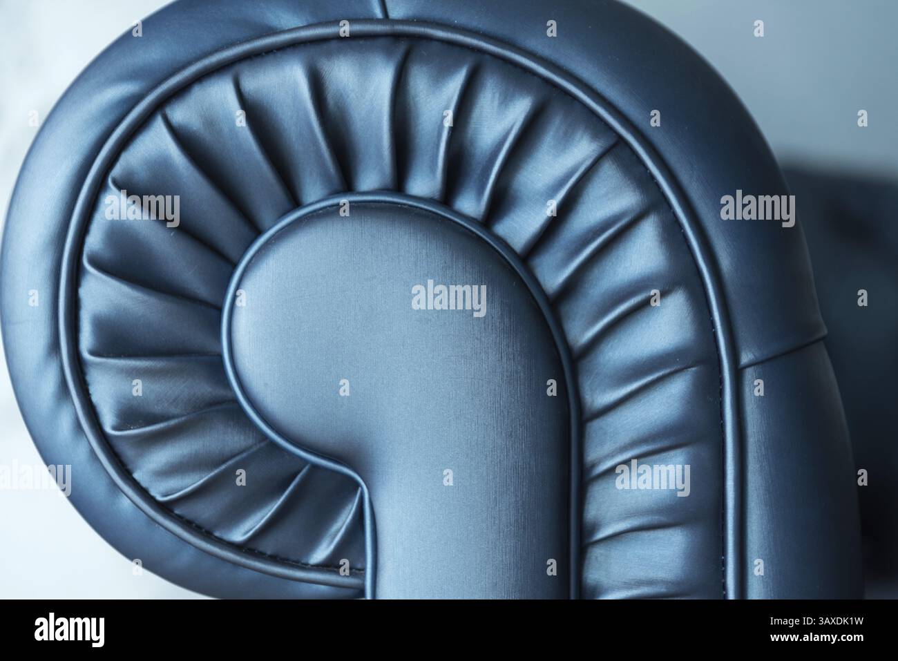 Detail of a couch backrest - glossy blue leather couch with scroll ...