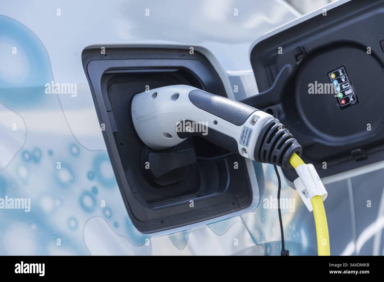 Electric car charging - Electric car plugged in at the charging station ...