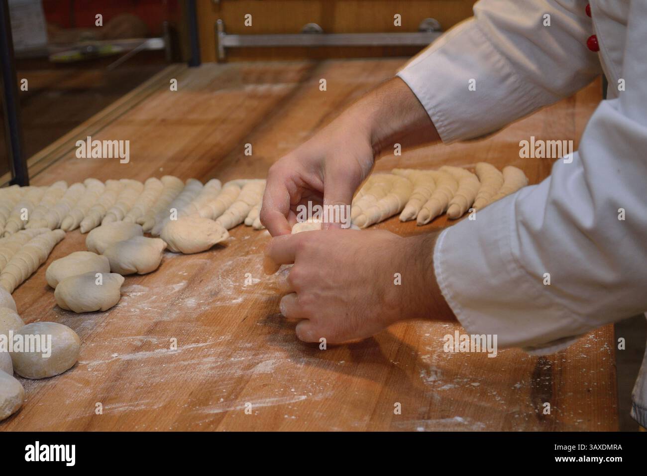 Baker moulds hand rolls and salted sticks Stock Photo - Alamy