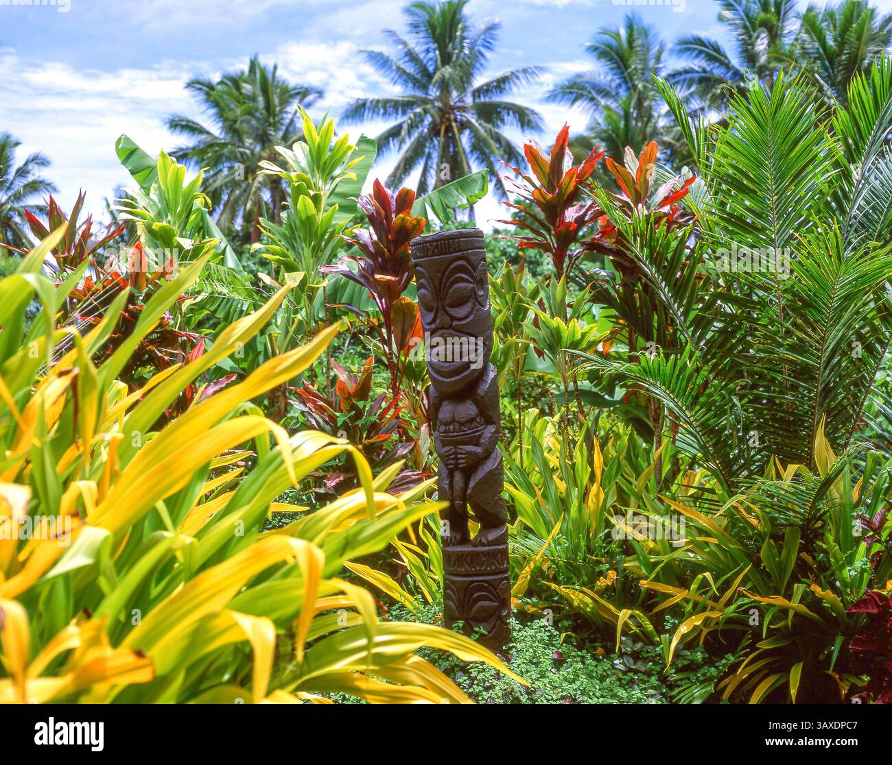 Carved Polynesian pole in tropical gardens, Rarotonga, Cook Islands ...