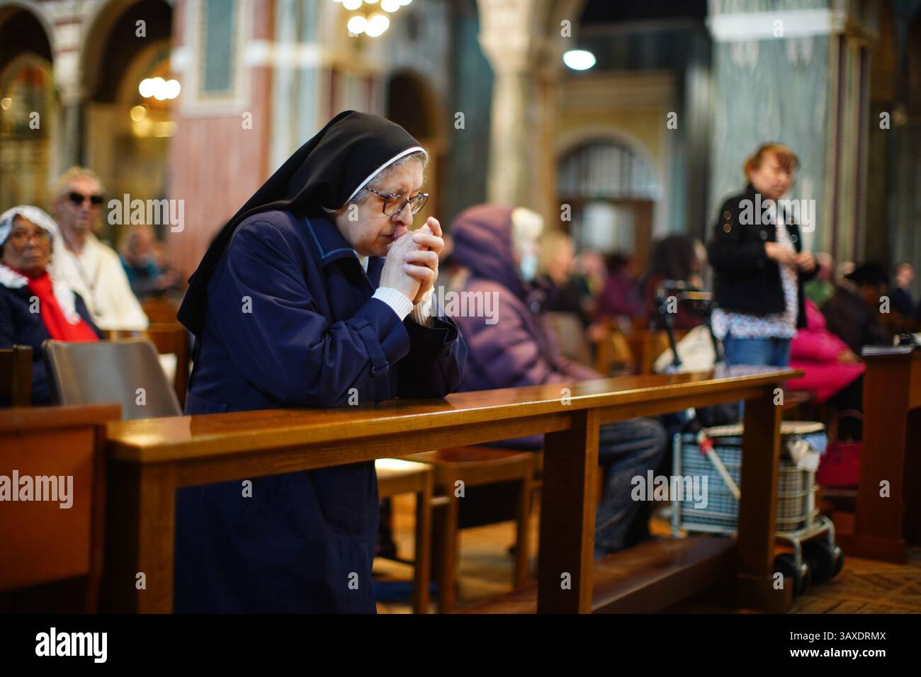 A nun prays in Westminster Cathedral in Victoria, London, following the ...
