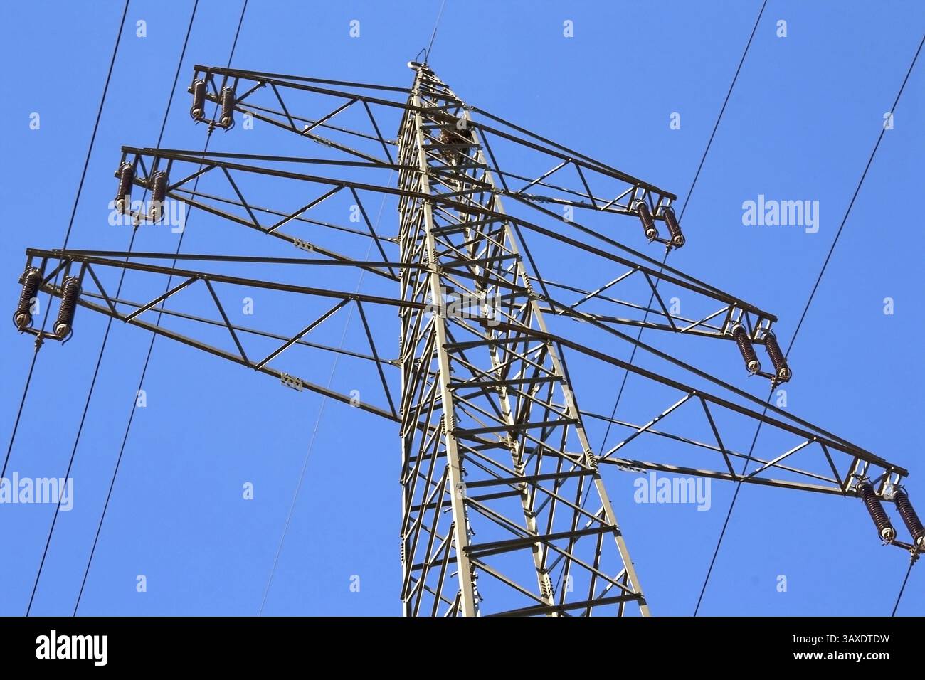 High-voltage pylon against blue sky Electricity pylon against blue sky ...