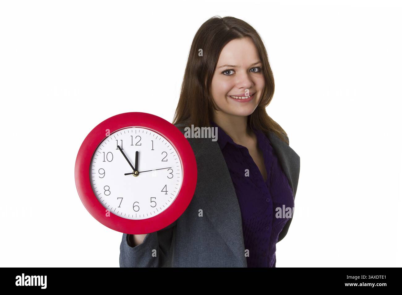 Woman in grey suit holding a red clock - isolated Woman in grey suit ...