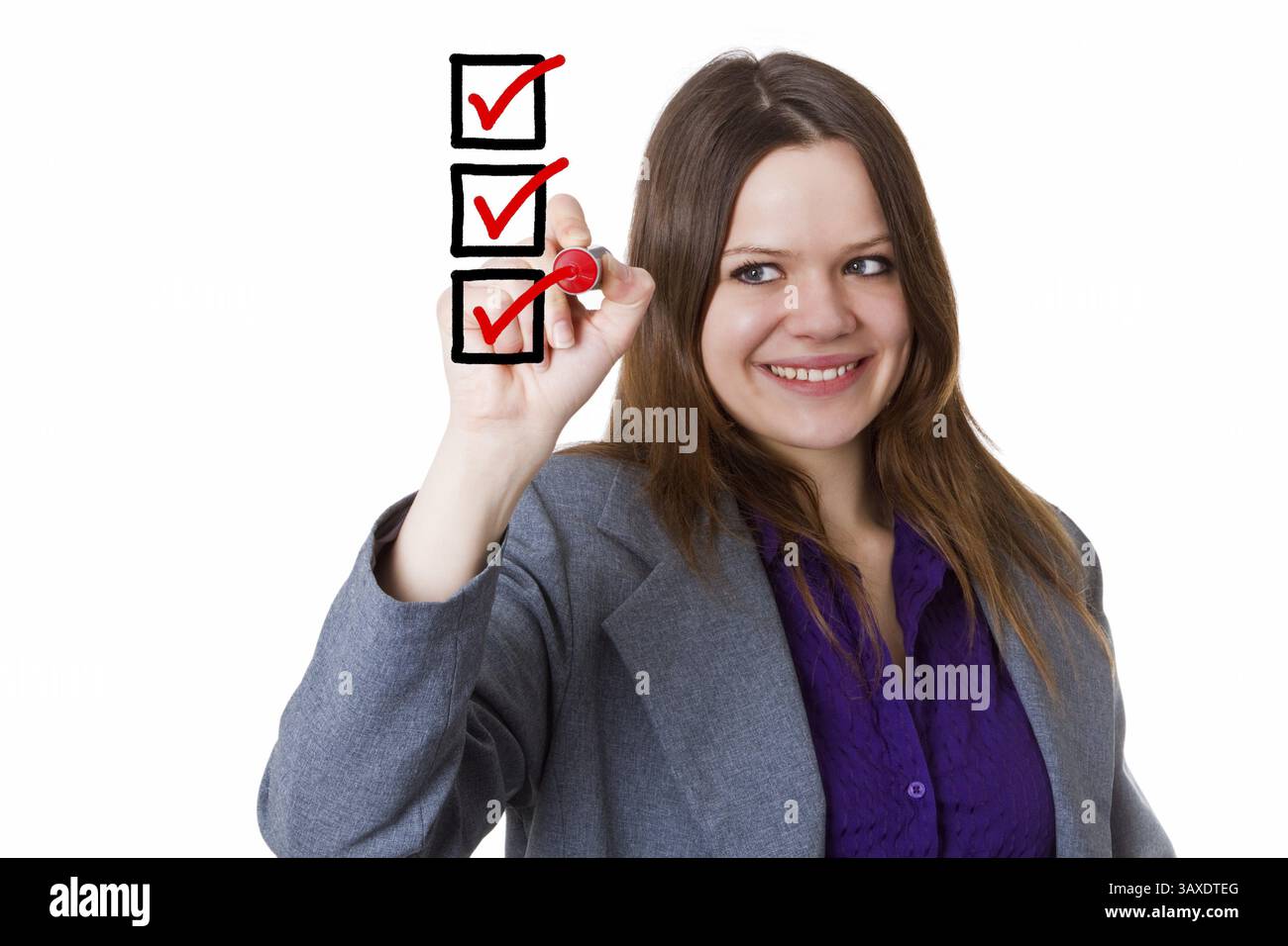Young woman making check marks on a glass panel - isolated Young woman ...