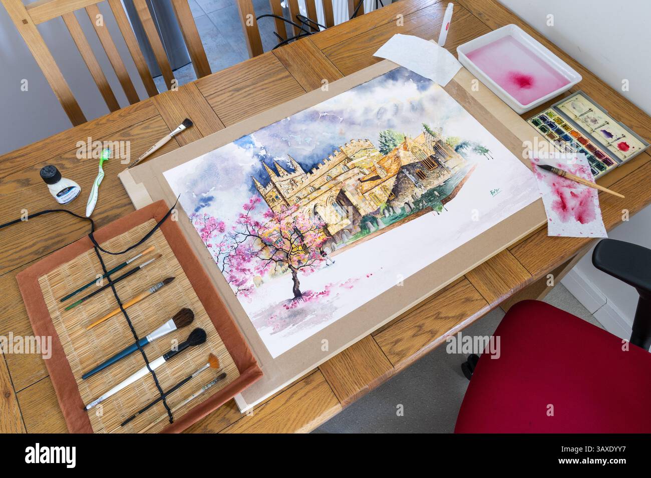 A completed watercolour painting on a drawing board with watercolour ...