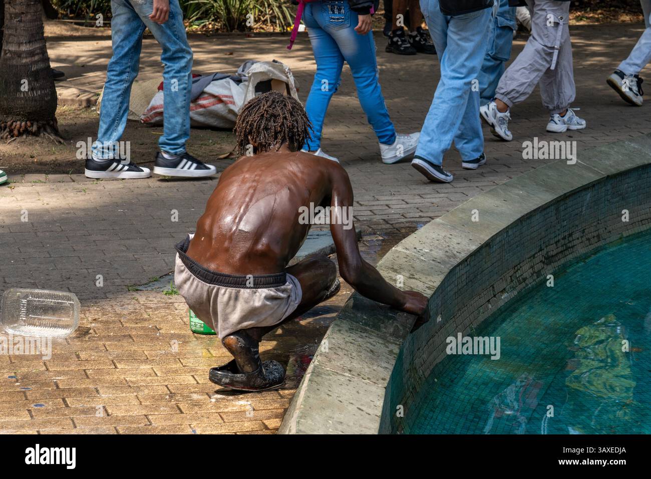 A homeless person washing himself in a fountain in Bolivar Park in ...