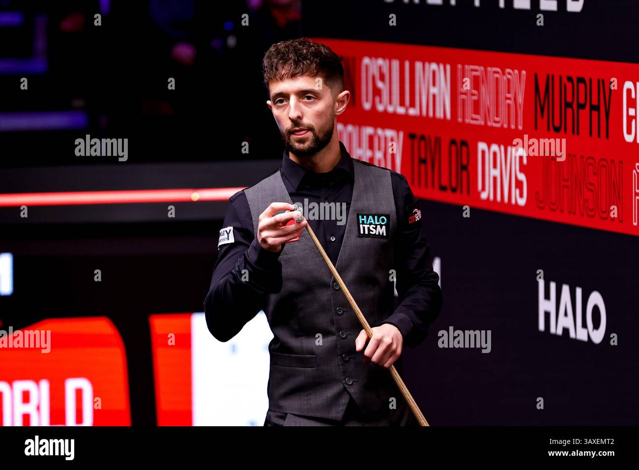 Joe O'Connor checks the score during the 2025 Halo World Snooker ...