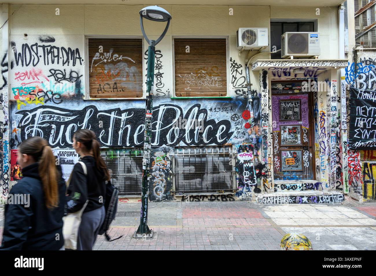 Anarchist and Anti-police graffiti on the facade of a squat in the ...