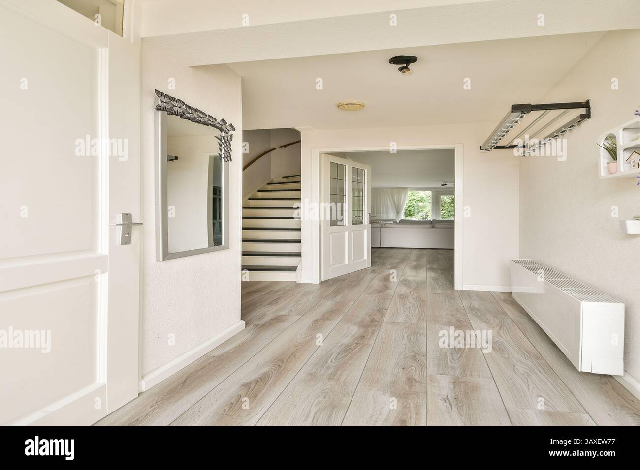 A well-lit interior showcasing elegant flooring and a staircase ...