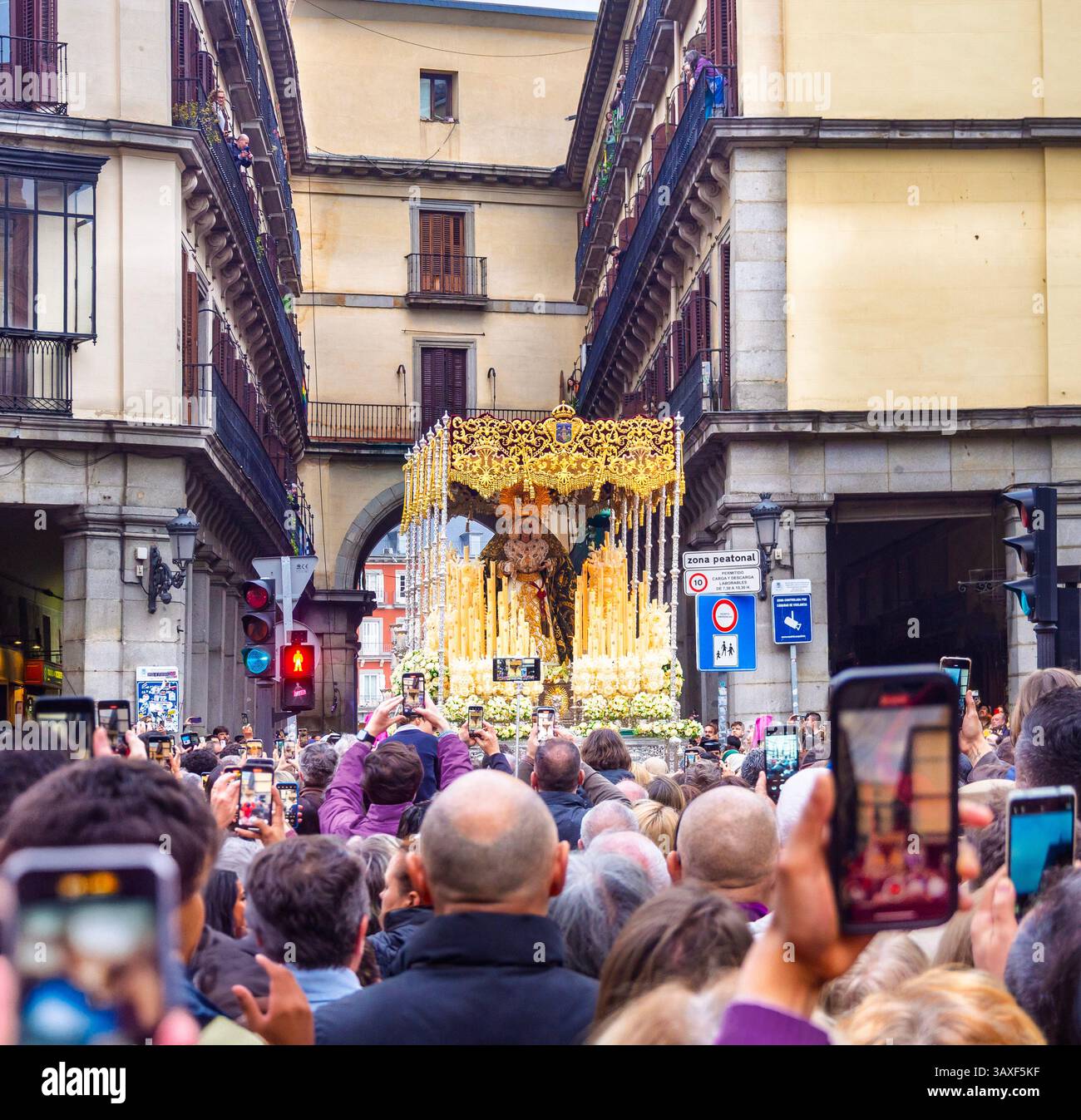Crowd of people with raised phones watch the religious procession of ...