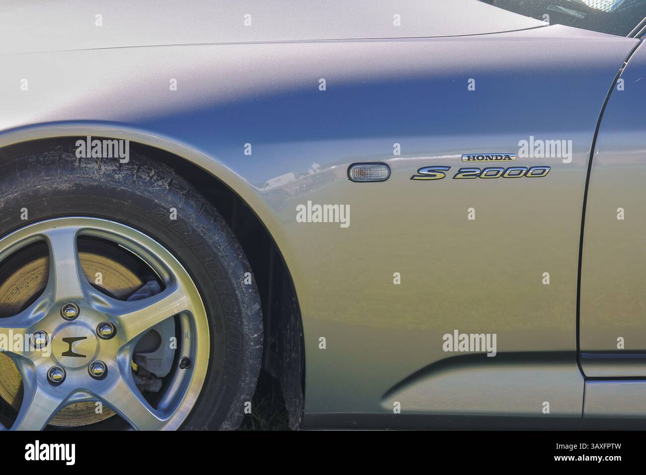 Polished silver honda s2000 showcasing its fender, wheel, and iconic ...