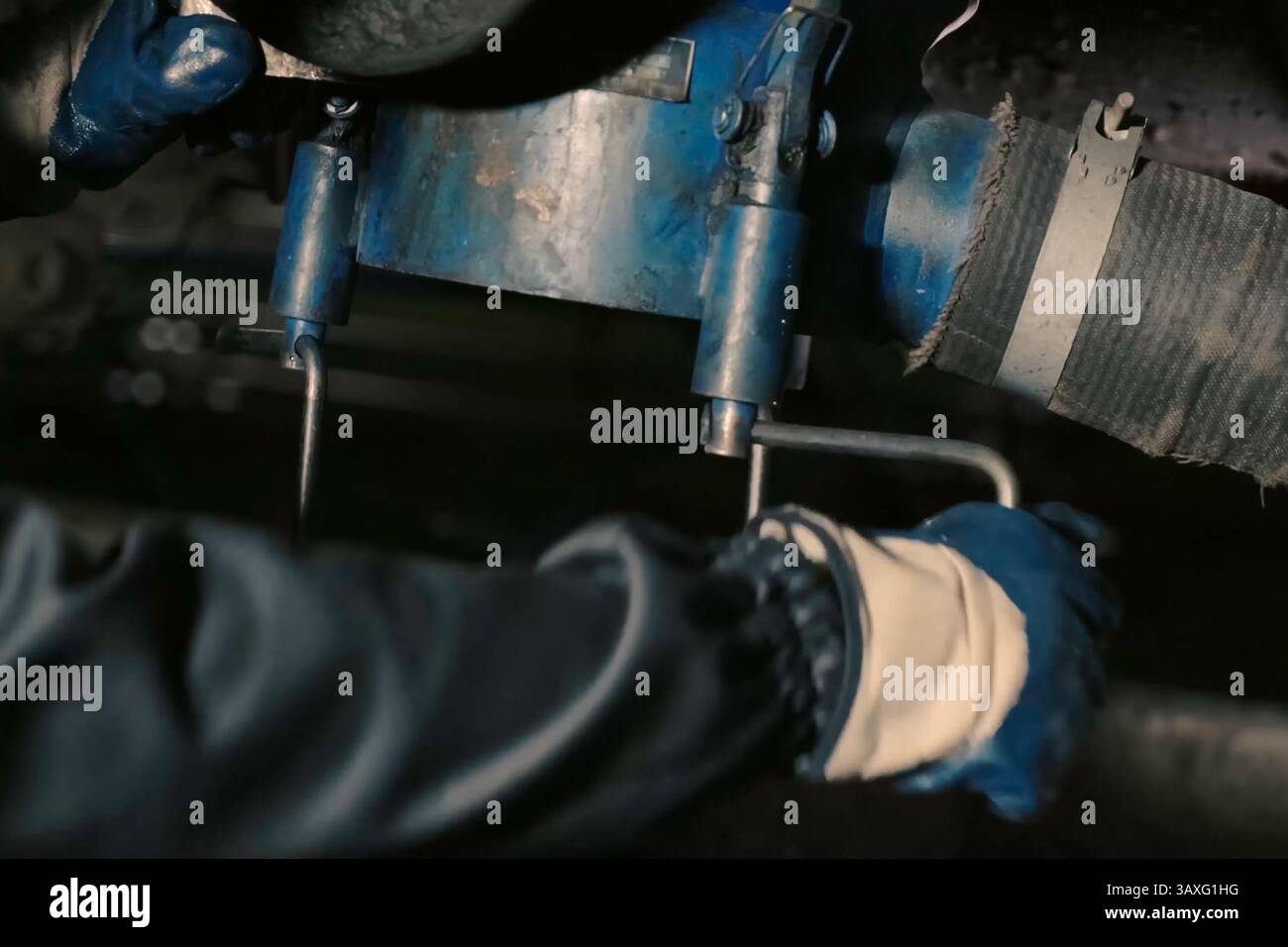 Installation of the drain hose to the road tanker Stock Photo - Alamy