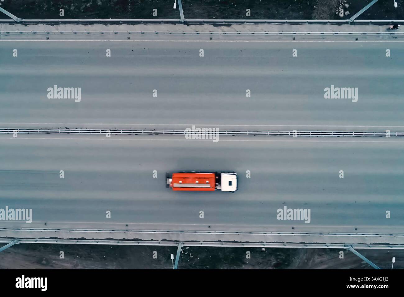 A truck with an orange fuel tank is driving across the bridge Stock ...