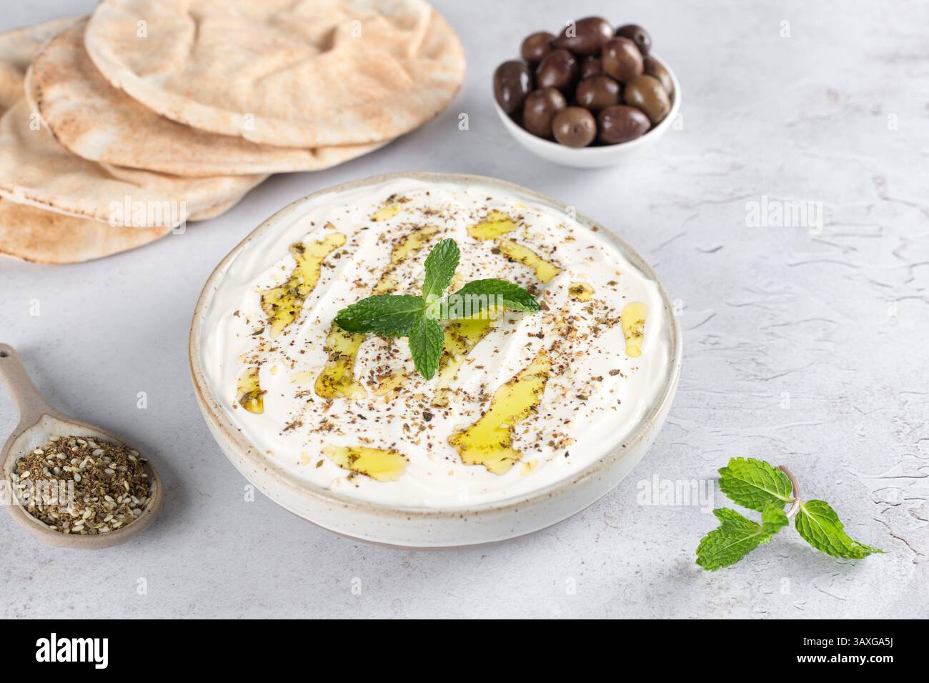 Traditional Middle Eastern appetizer of labneh cheese with olive oil ...