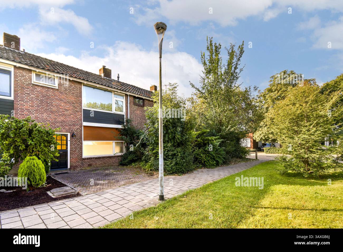 A picturesque view of a residential pathway lined with lush greenery ...