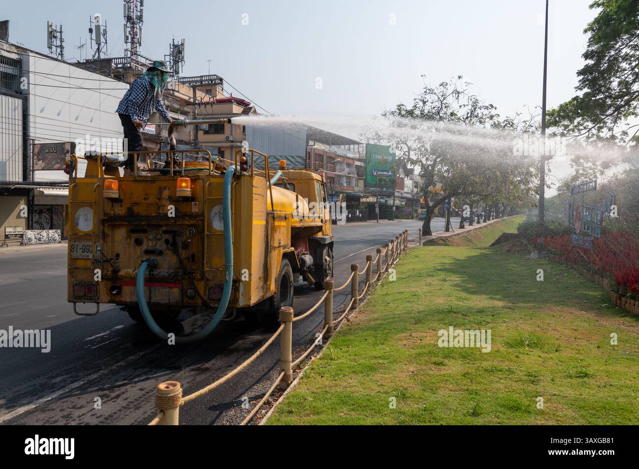 A local parks employee using a water pressure jet hose from a mobile ...
