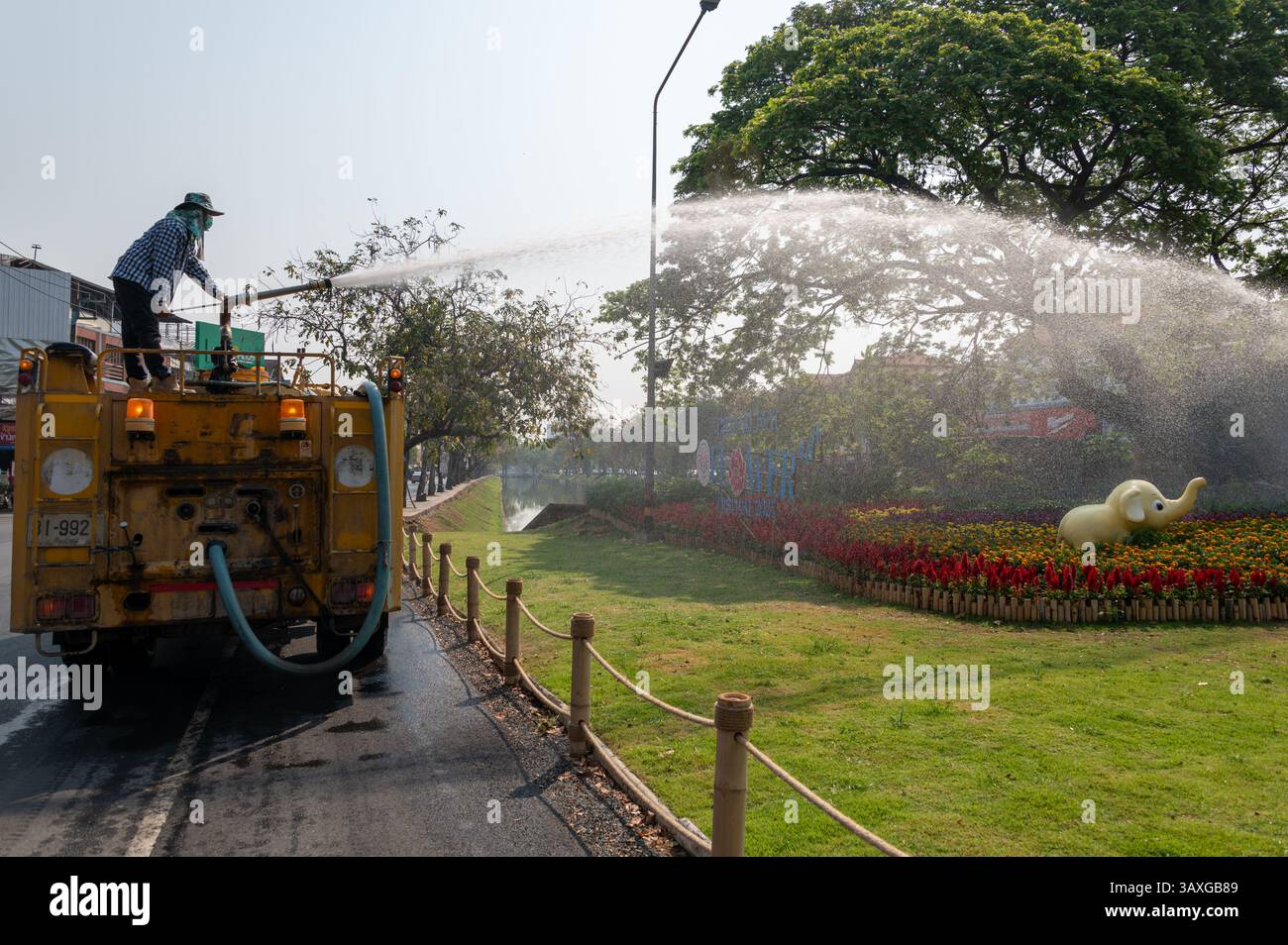 A local parks employee using a water pressure jet hose from a mobile ...