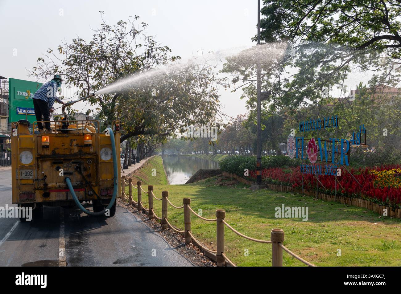 A local parks employee using a water pressure jet hose from a mobile ...