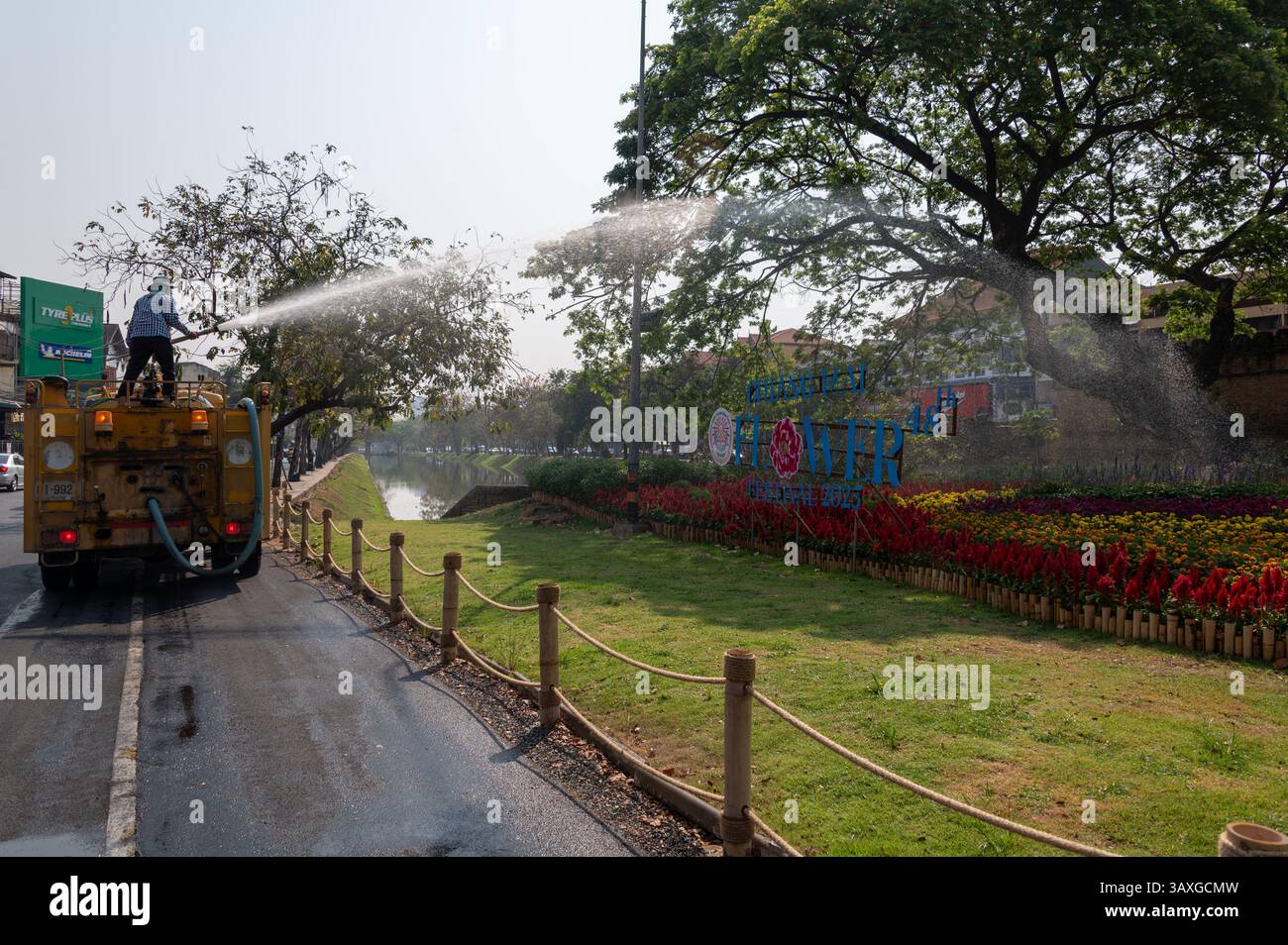 A local parks employee using a water pressure jet hose from a mobile ...