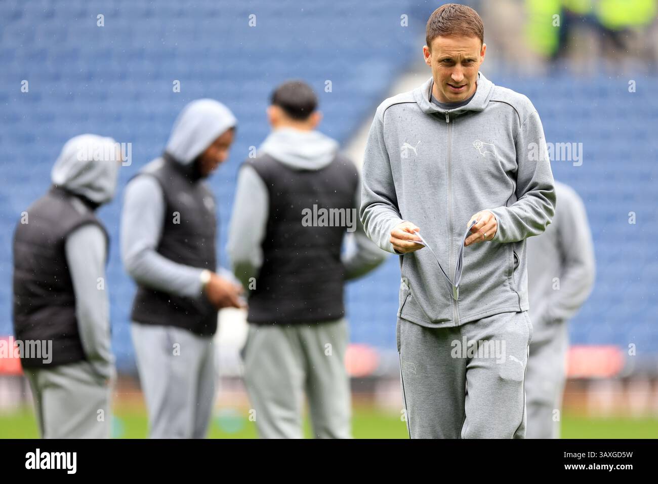 Derby County's Craig Forsyth reads the match day programme before the ...