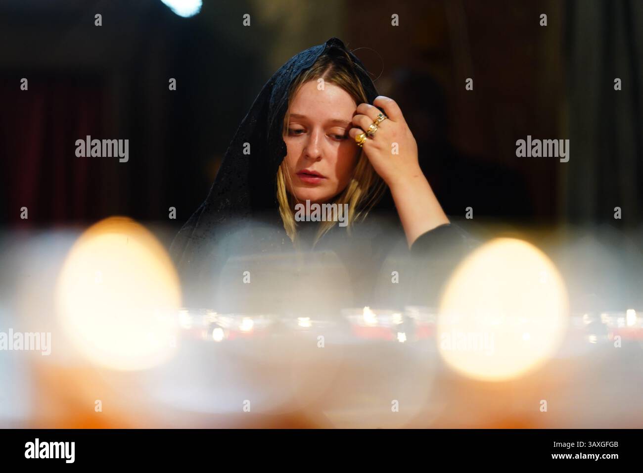A woman sits alone at Westminster Cathedral in Victoria, London ...