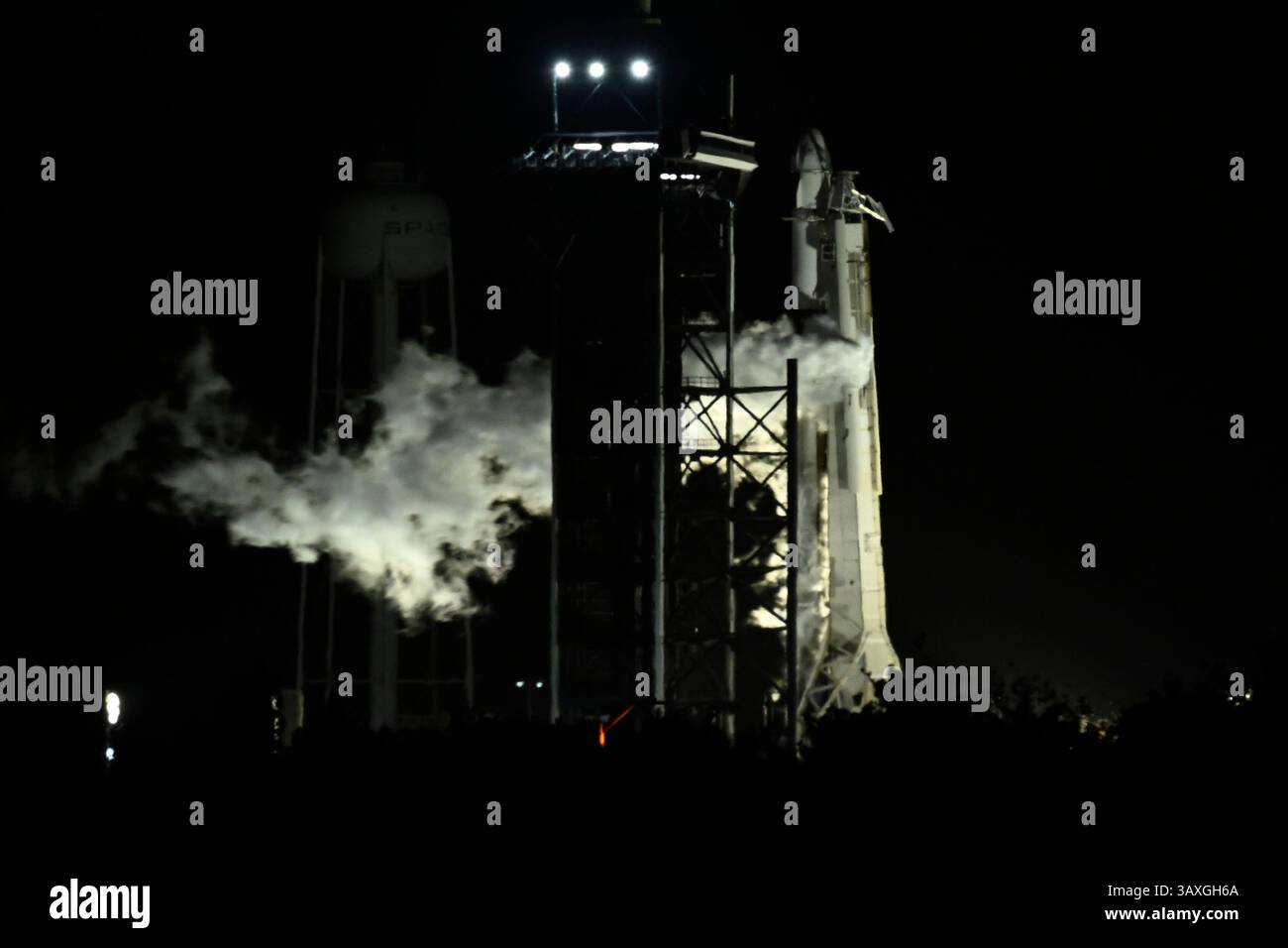 A SpaceX Falcon 9 rocket stands on the pad and vents just prior to ...