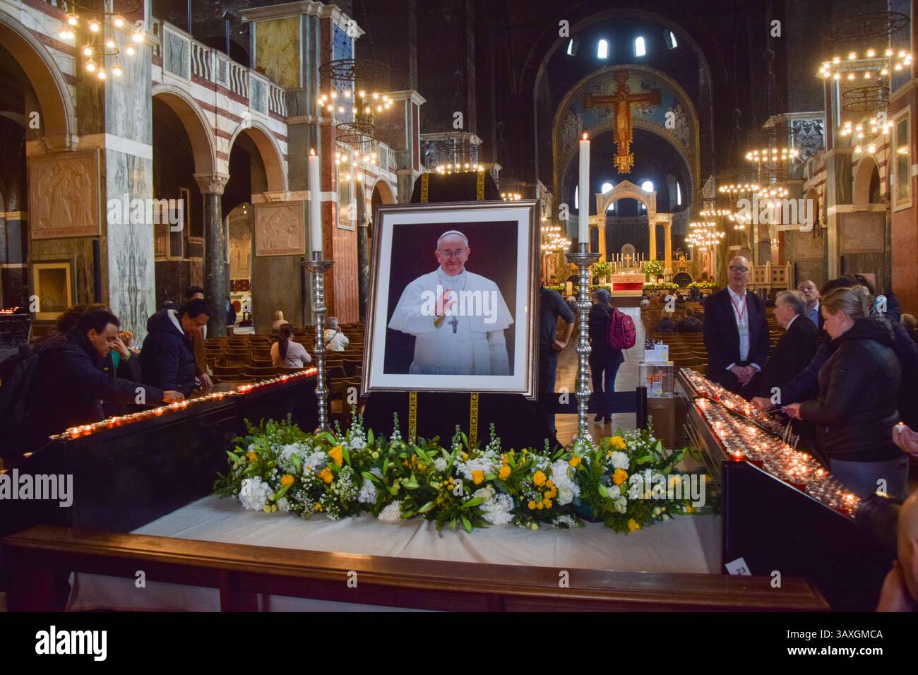 London, England, UK. 21st Apr, 2025. People light candles next to a ...