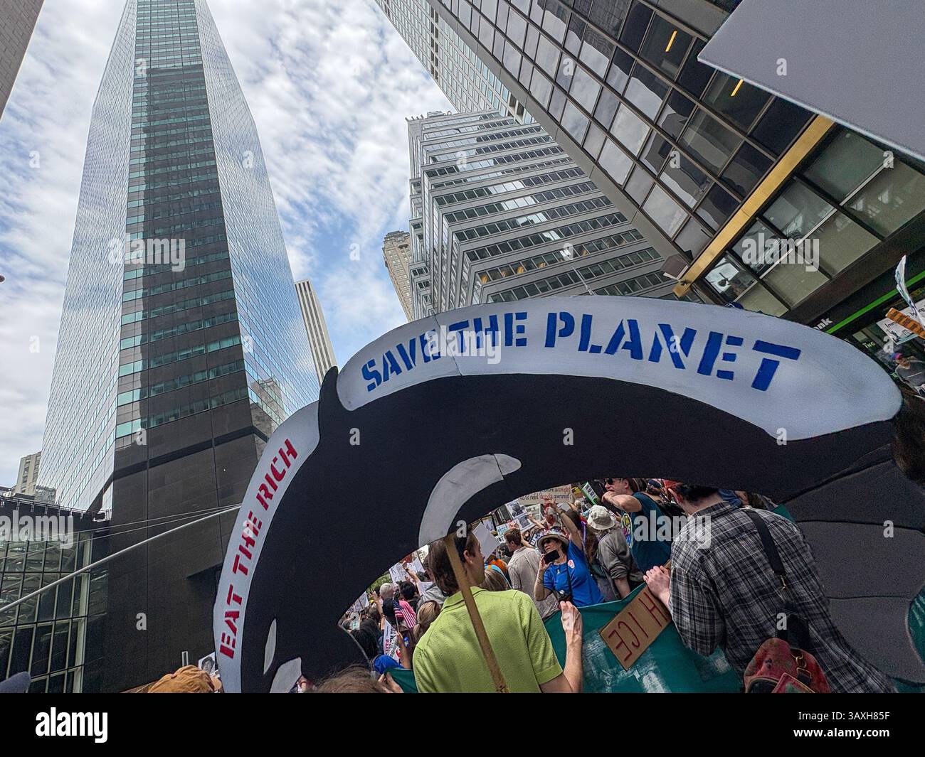 New York, United States. 19th Apr, 2025. Protesters walk under 'Eat the ...