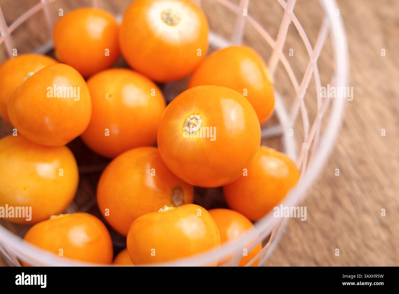 Raw Physalis peruviana fruits in supermarket plastic basket. Ground ...