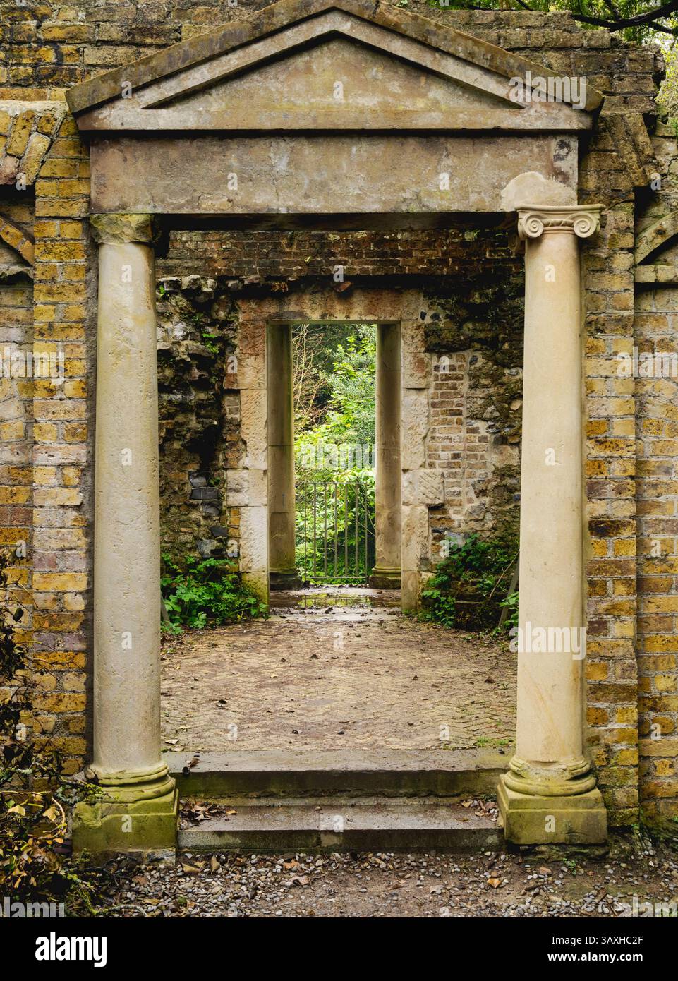 stone archway supported by classical columns, leading into a garden ...
