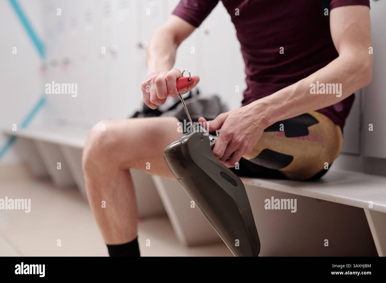 Disabled sportsman fixing leg hi-res stock photography and images - Alamy