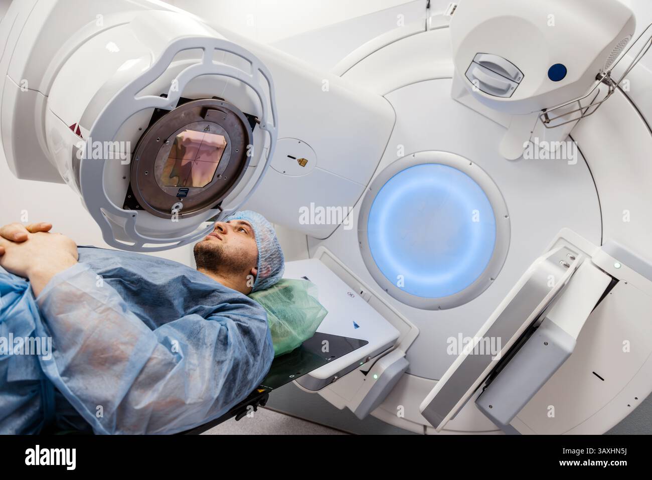 A young man undergoing radiation therapy for cancer in a state-of-the ...