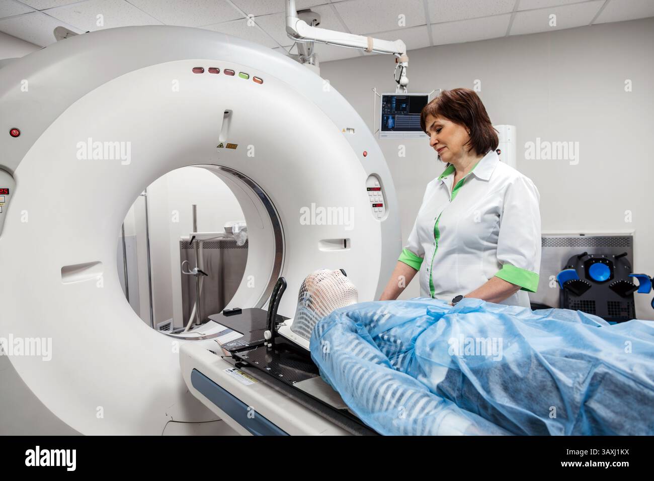 Specialists are preparing the young woman for radiation therapy by ...