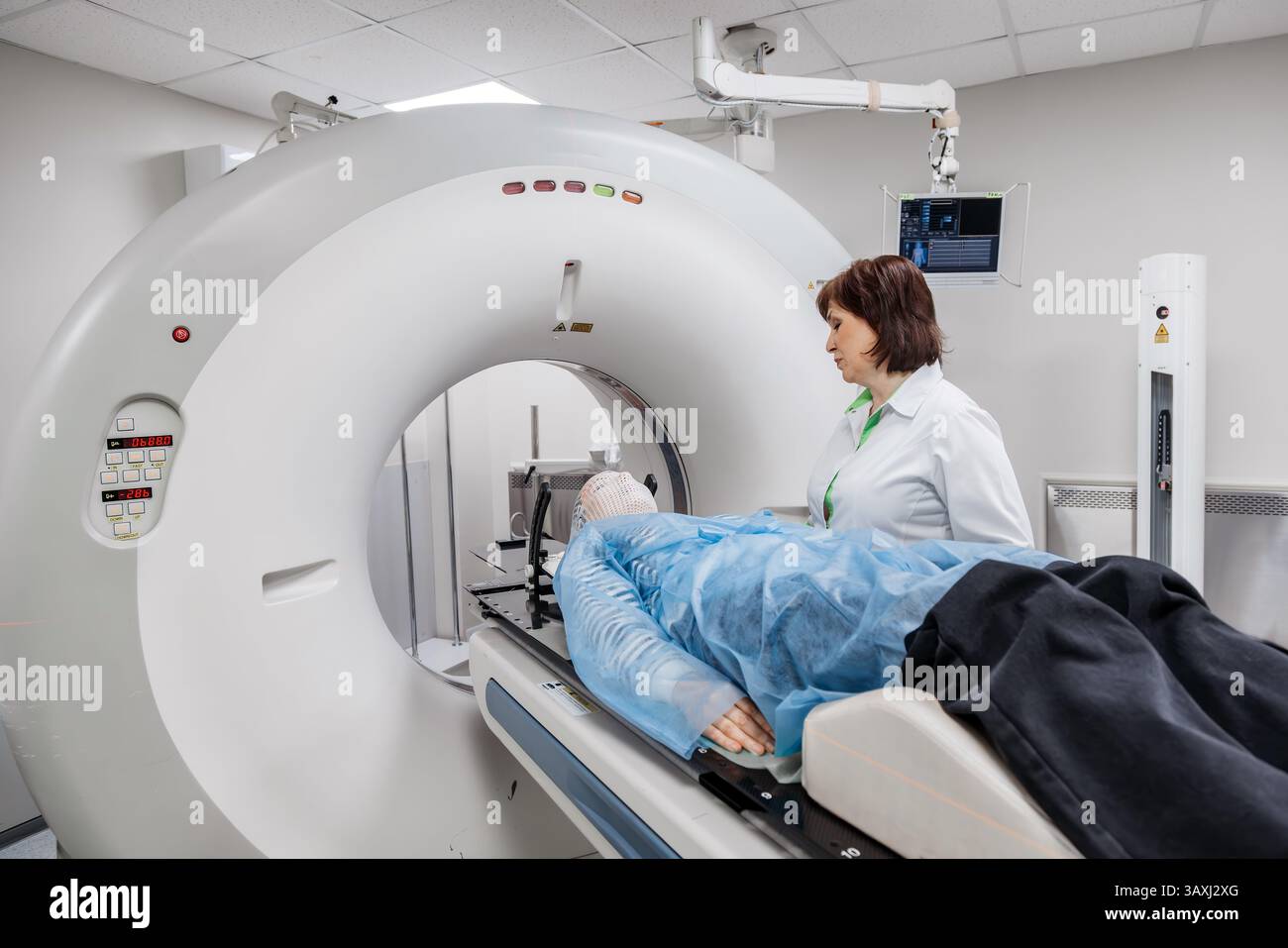 Specialists are preparing the young woman for radiation therapy by ...