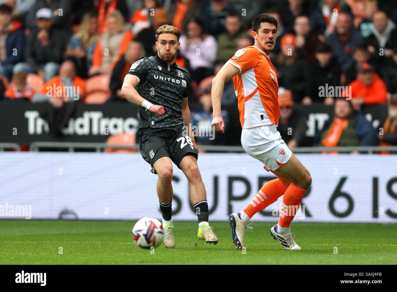 Wrexham's Sam Smith (left) and Blackpool's Elkan Baggott battle for the ...