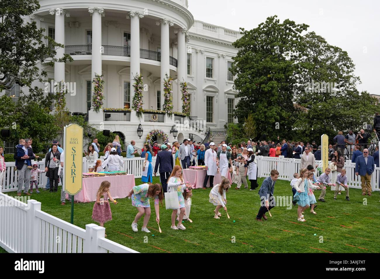 Guests arrive on the South Lawn of the White House before President Donald Trump and first lady ...