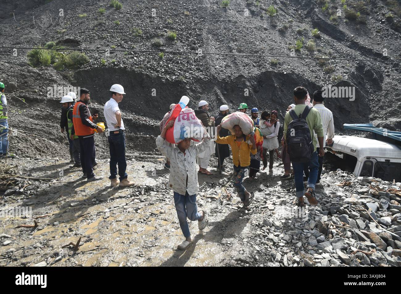 April 21, 2025, Ramban, Jammu And Kashmir, India: People walk over rocks on the blocked on the ...