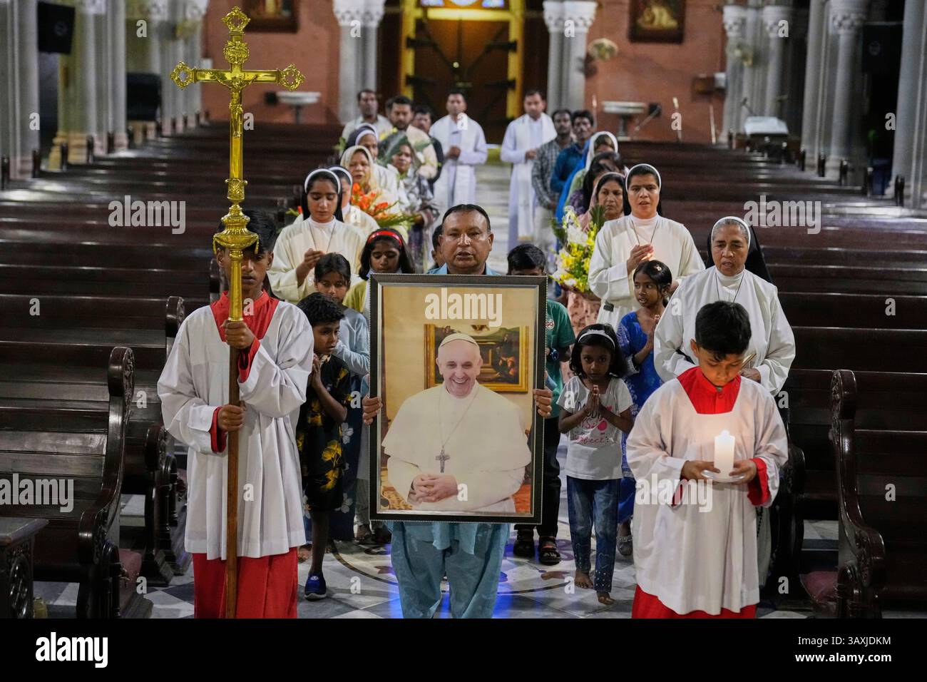 Christians arrive with a portrait of Pope Francis for a prayer ceremony ...