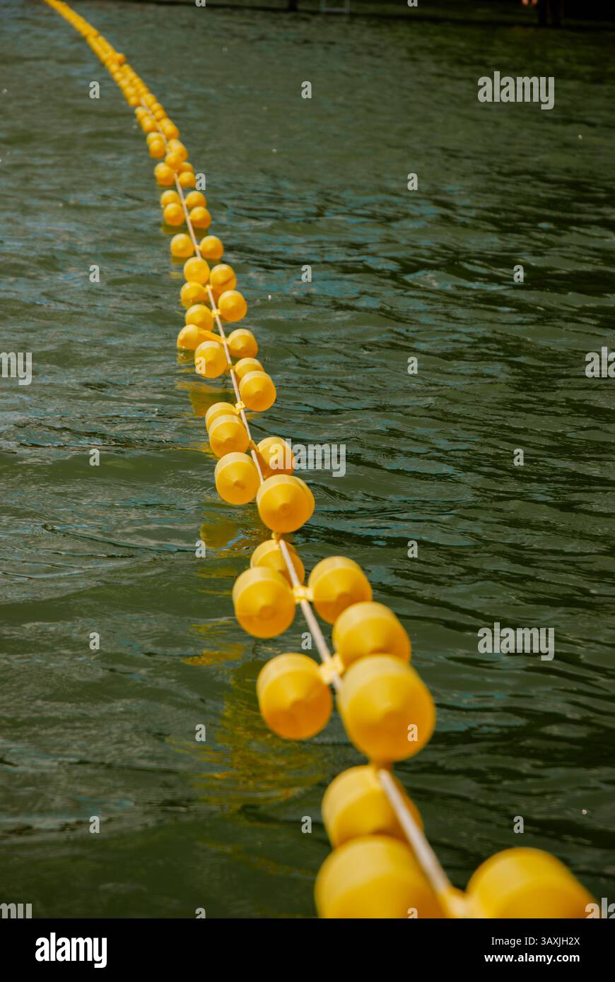 Bright yellow buoys floating in calm water with nautical theme for ...