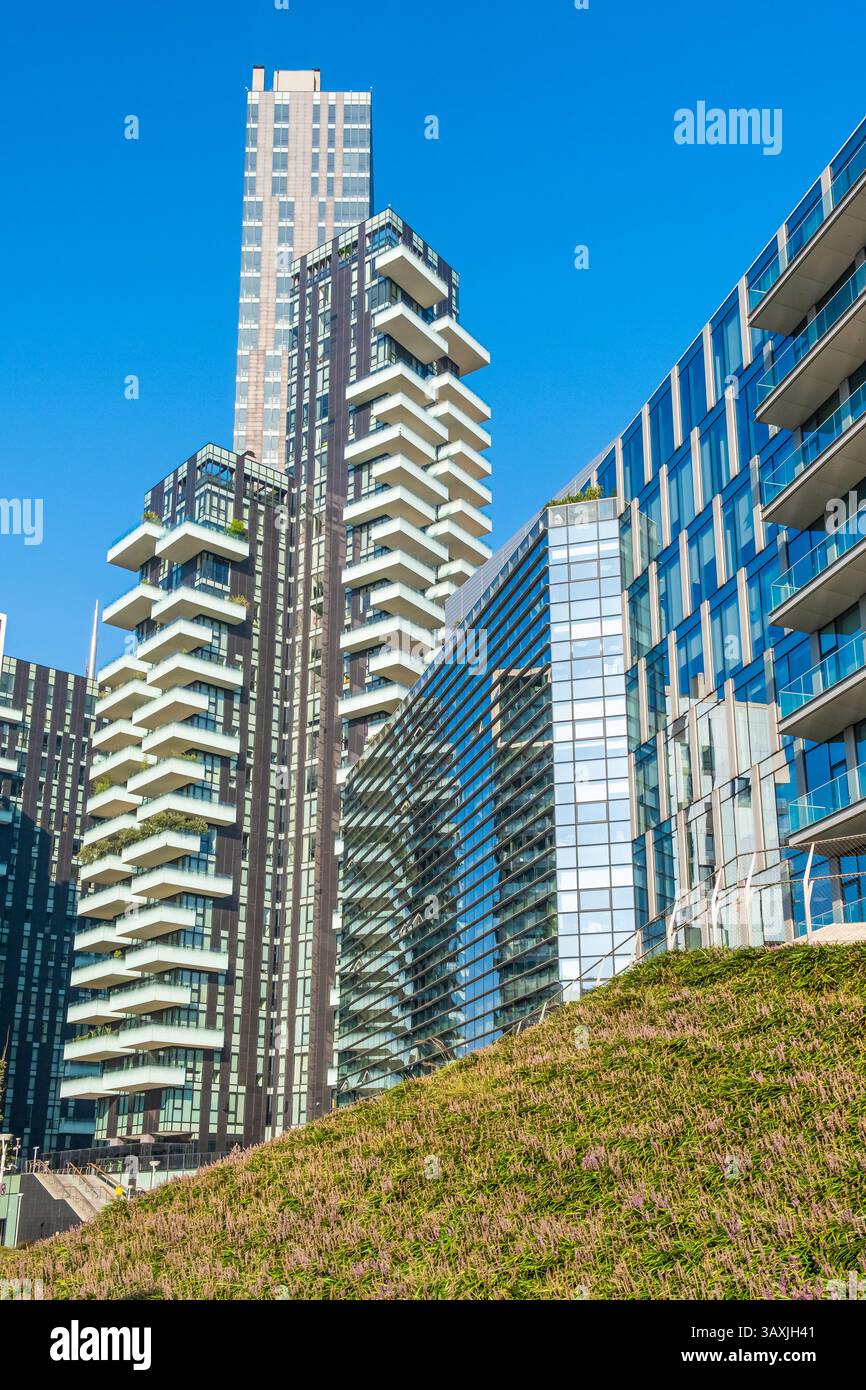 Contemporary high-rise buildings with stacked balconies and reflective ...