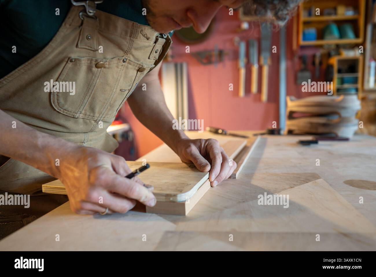 Close up carpenter marking angles and drill positions on wooden board ...