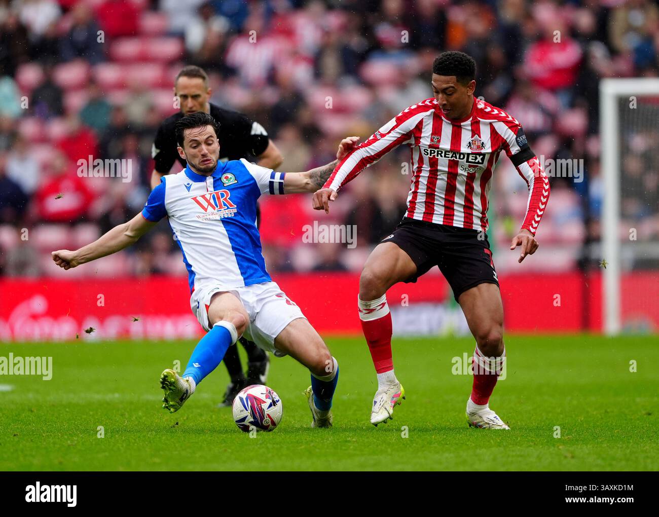 Blackburn Rovers' Lewis Travis (left) and Sunderland's Jobe Bellingham ...