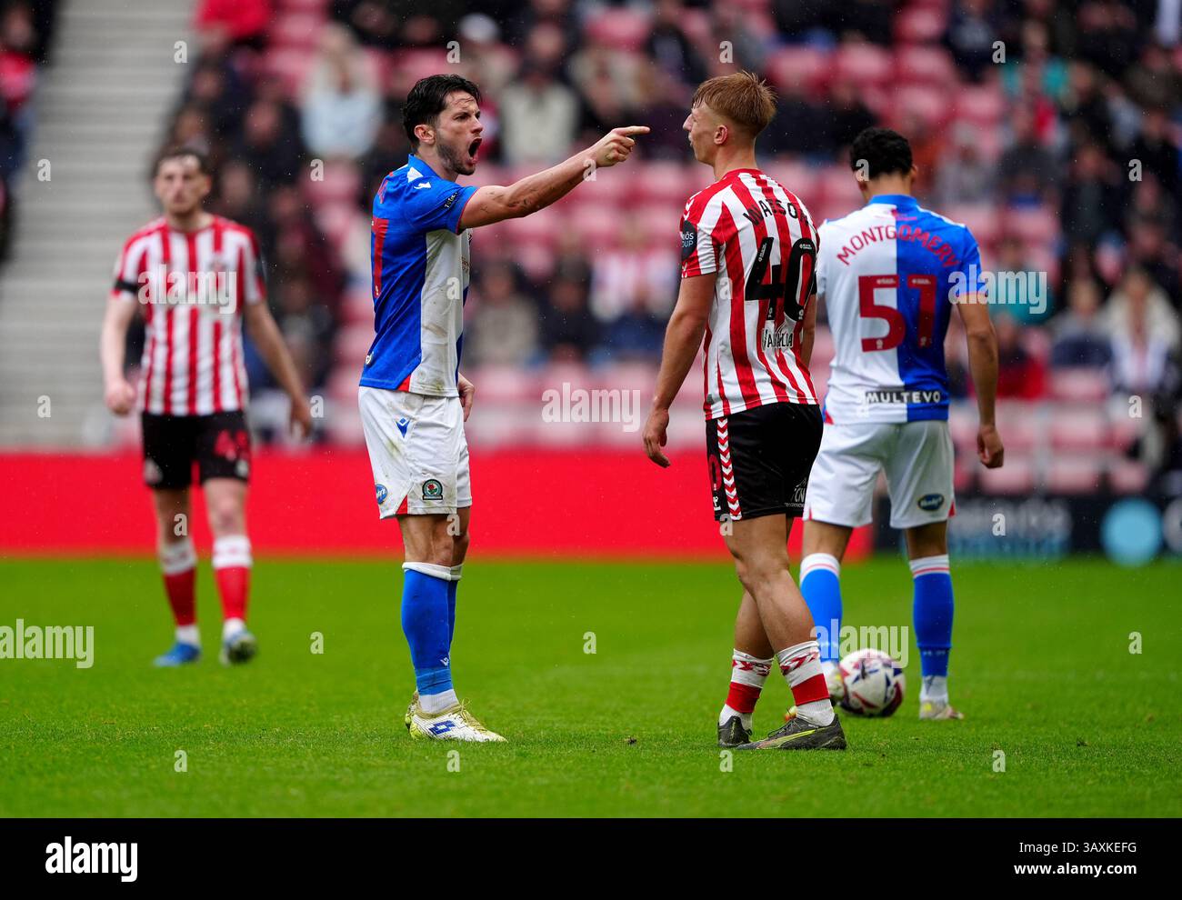 Blackburn Rovers' Lewis Travis (left) confronts Sunderland's Tom Watson ...