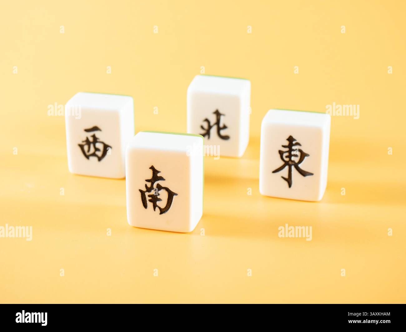 Four white mahjong tiles with Chinese characters, arranged on a bright ...