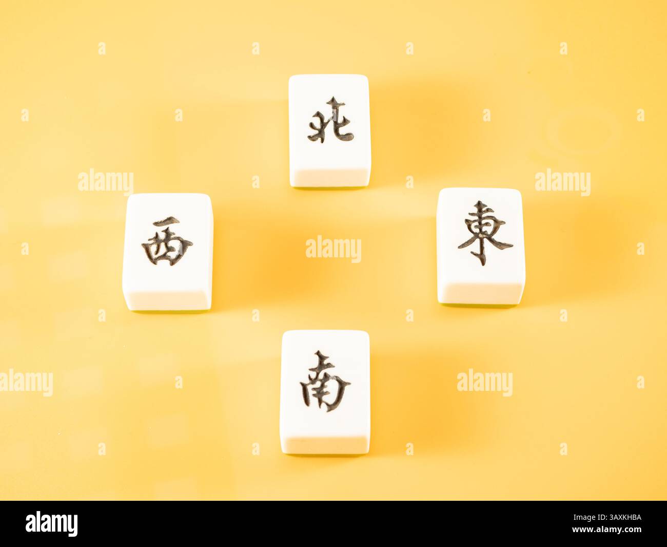 Four white mahjong tiles with Chinese characters, arranged on a bright ...