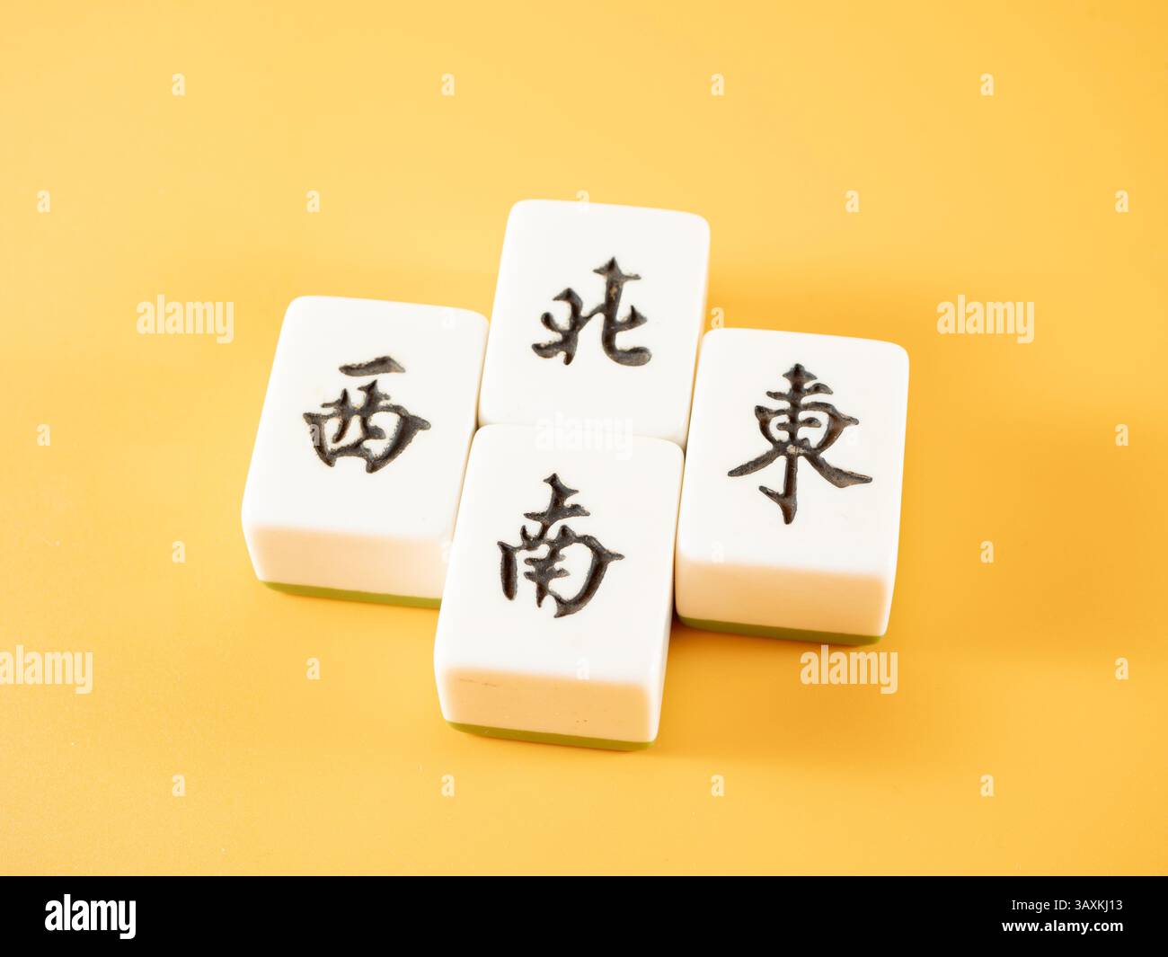 Four white mahjong tiles with Chinese characters, arranged on a bright ...