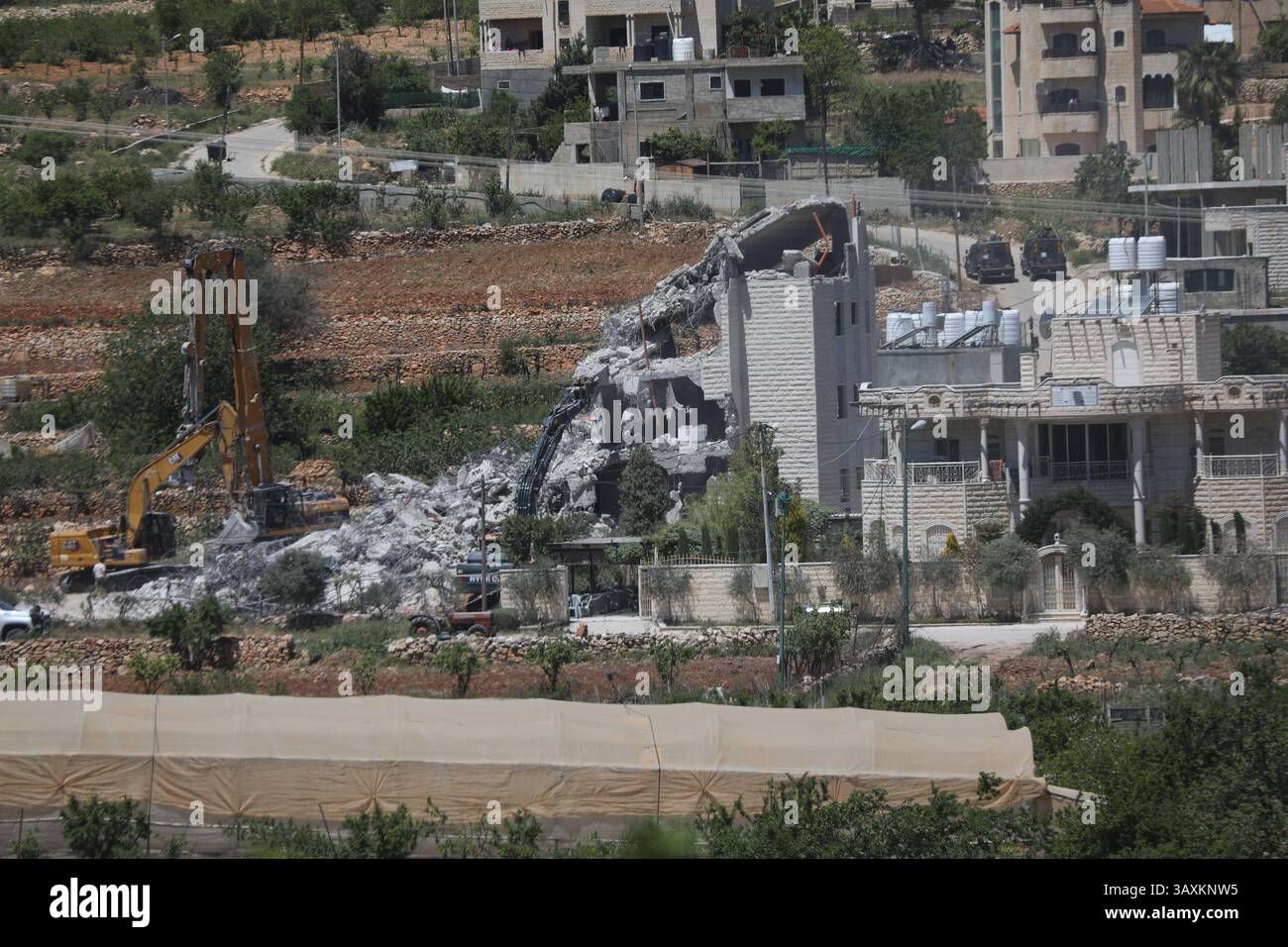 Israeli forces demolish a Palestinian-owned building that it was ...
