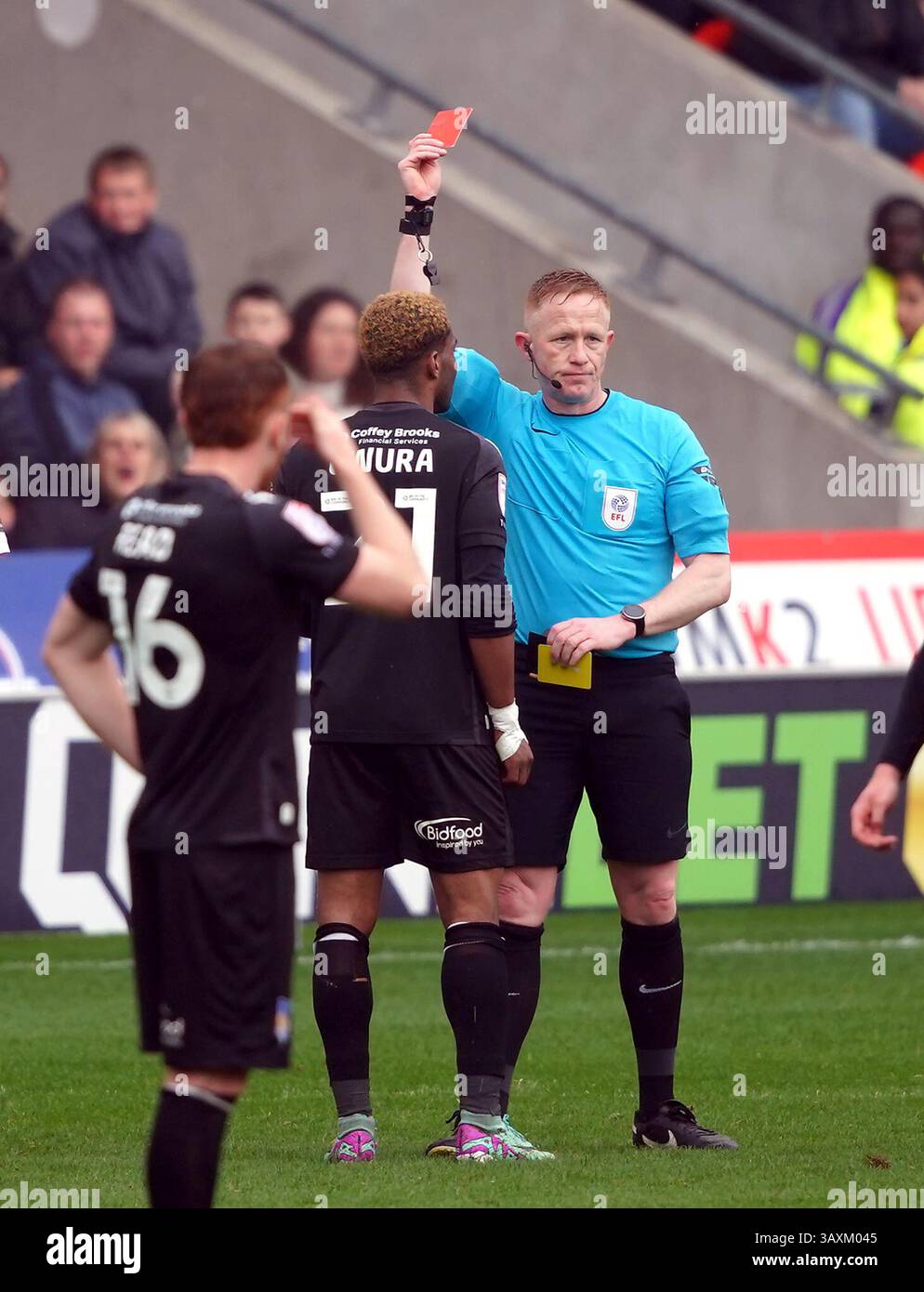 Colchester United's Owura Edwards is shown a red card by referee Alan ...